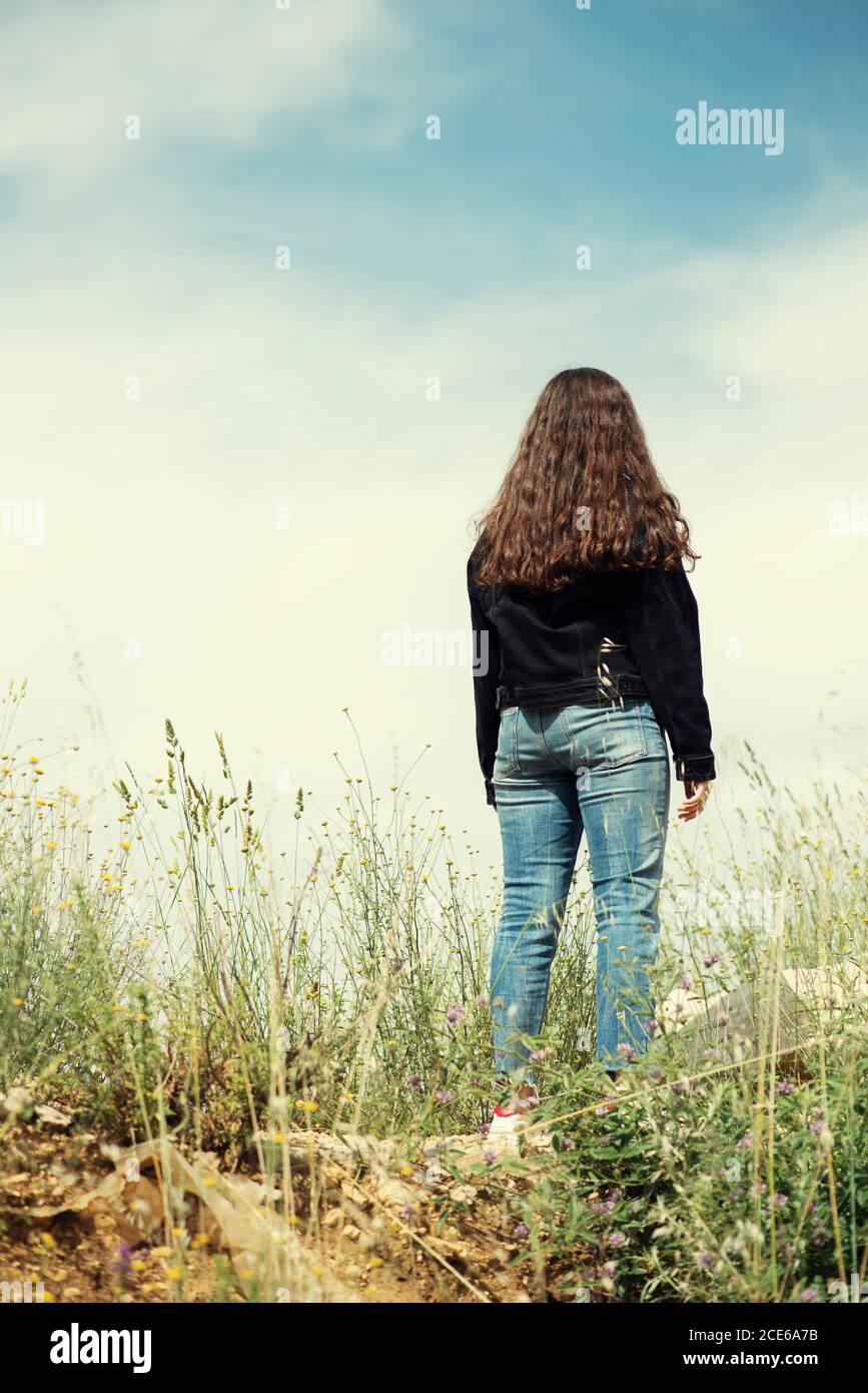 Rear view of teenage girl standing outdoors Stock Photo - Alamy