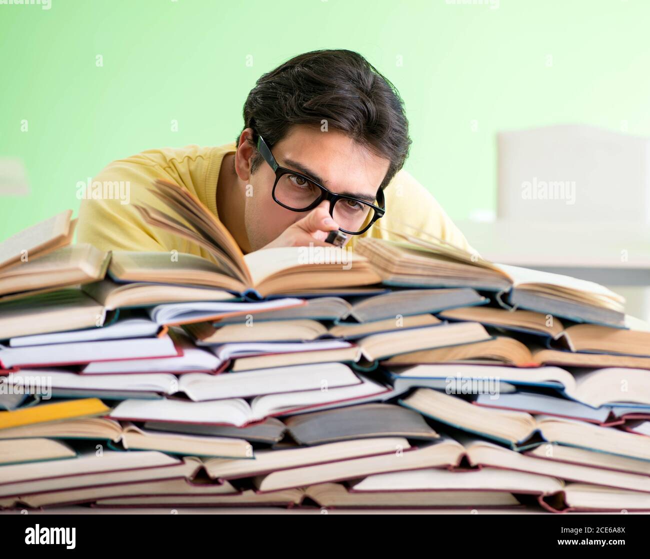 The student with too many books to read before exam Stock Photo - Alamy