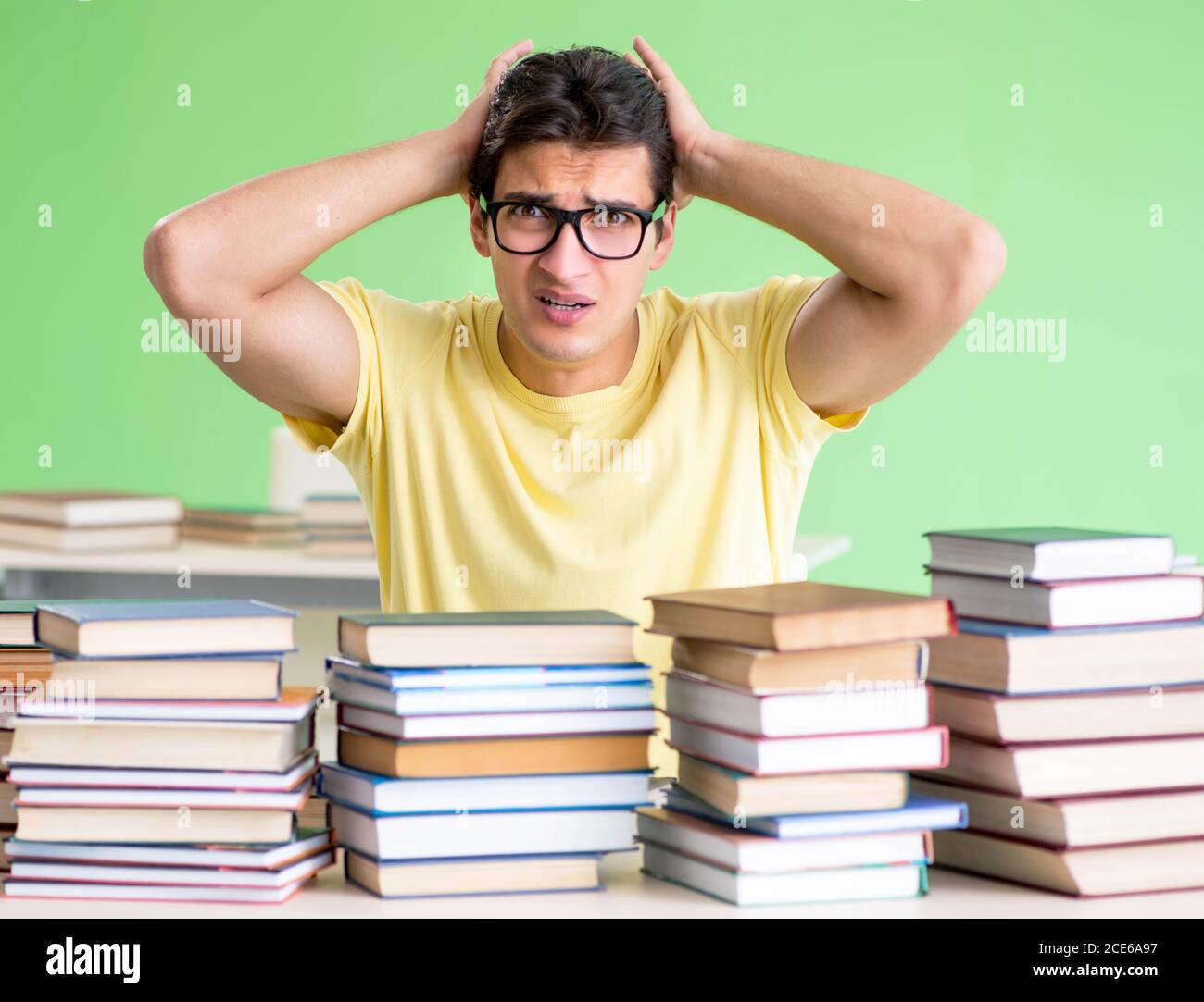 The student with too many books to read before exam Stock Photo - Alamy