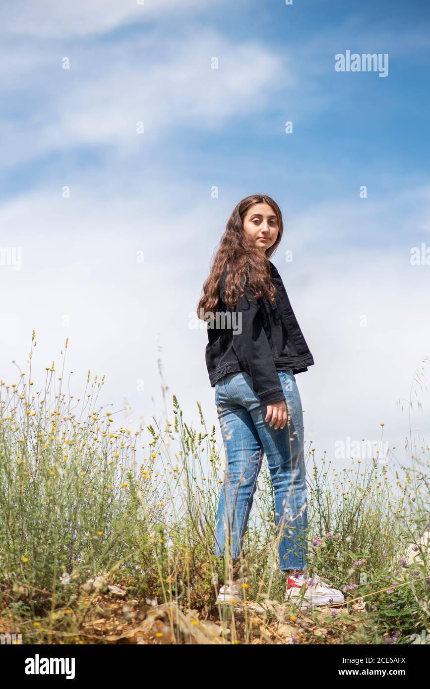 Teen girl looking over shoulder hi-res stock photography and images - Alamy