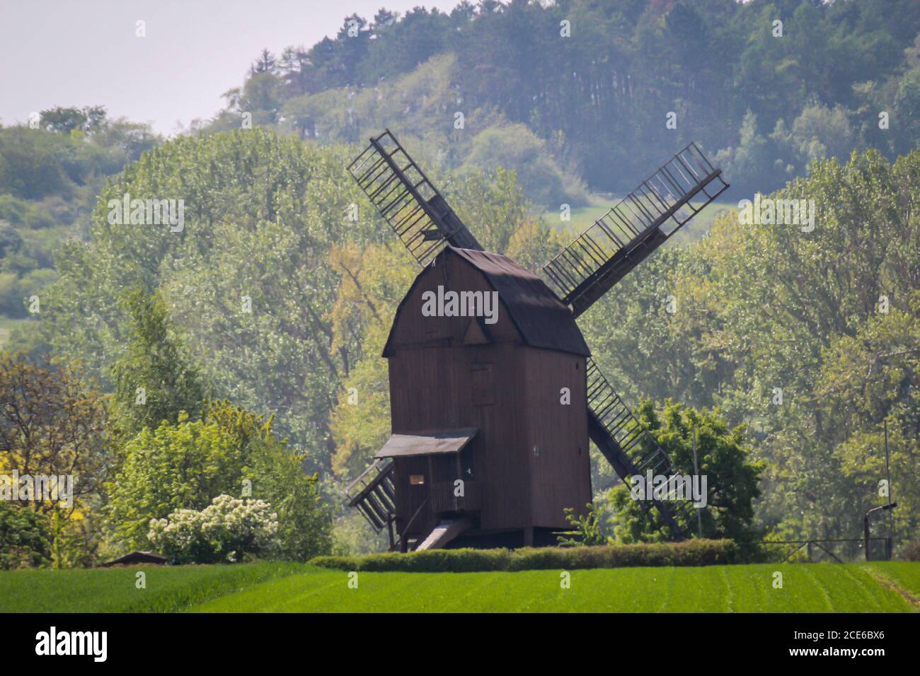 View of a well-preserved old post mill Stock Photo - Alamy