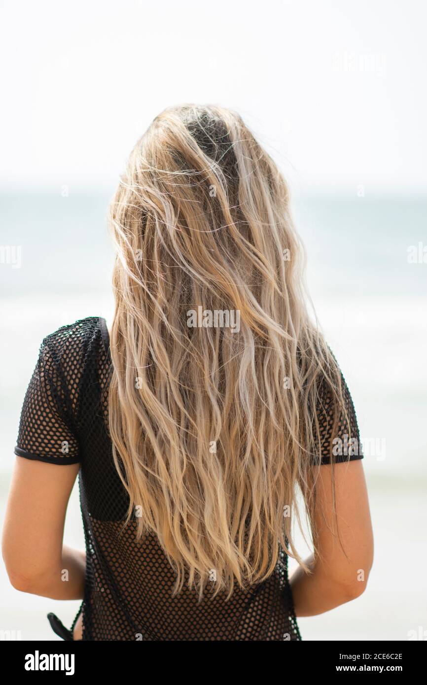 Rear view woman on the beach Stock Photo - Alamy