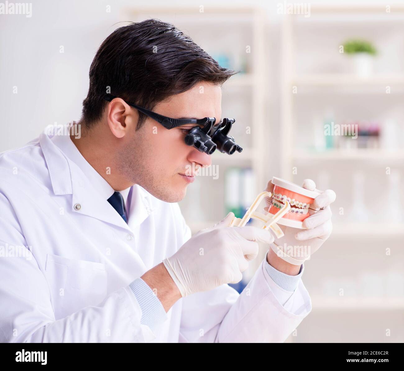 The young dentist working in the dentistry hospital Stock Photo - Alamy