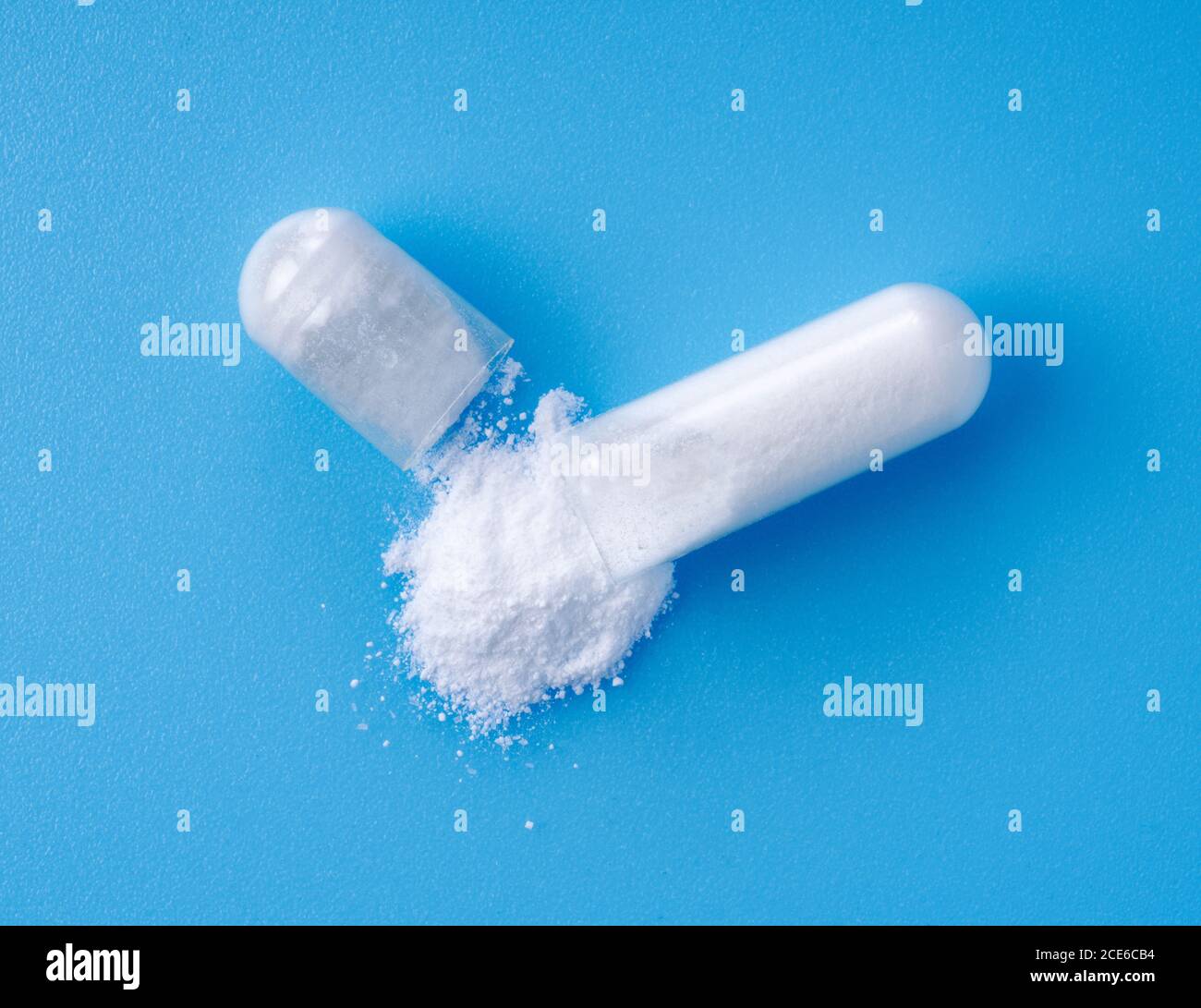 White capsules placed on blue background.Medical, health image Stock ...