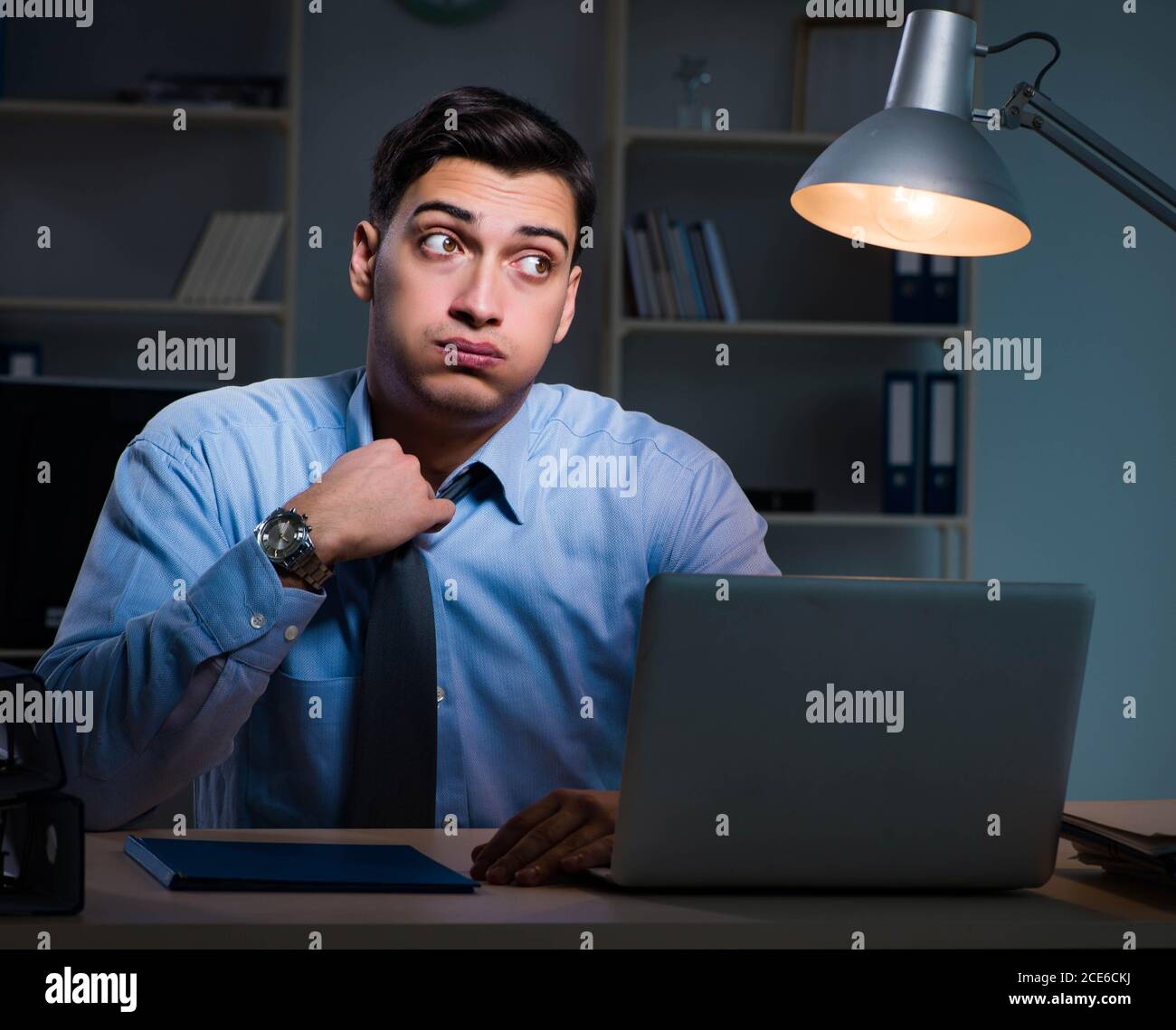 The employee working late at night at important report Stock Photo - Alamy