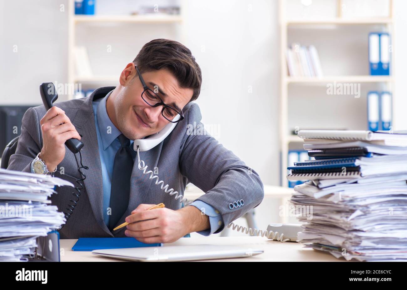 The desperate sad employee tired at his desk in call center Stock Photo ...