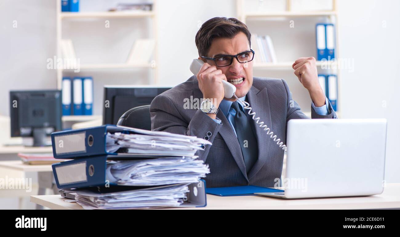 The desperate sad employee tired at his desk in call center Stock Photo ...