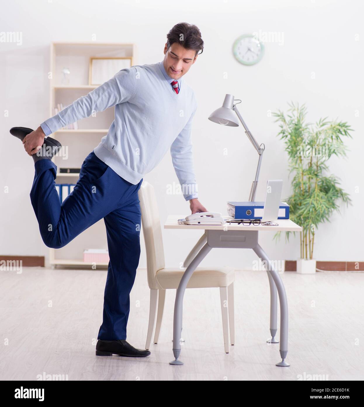 The employee doing stretching exercises in the office Stock Photo - Alamy