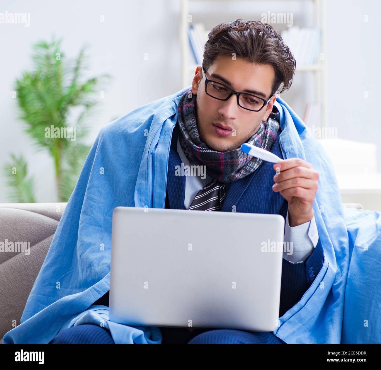 The sick businessman working from home due to flu sickness Stock Photo ...