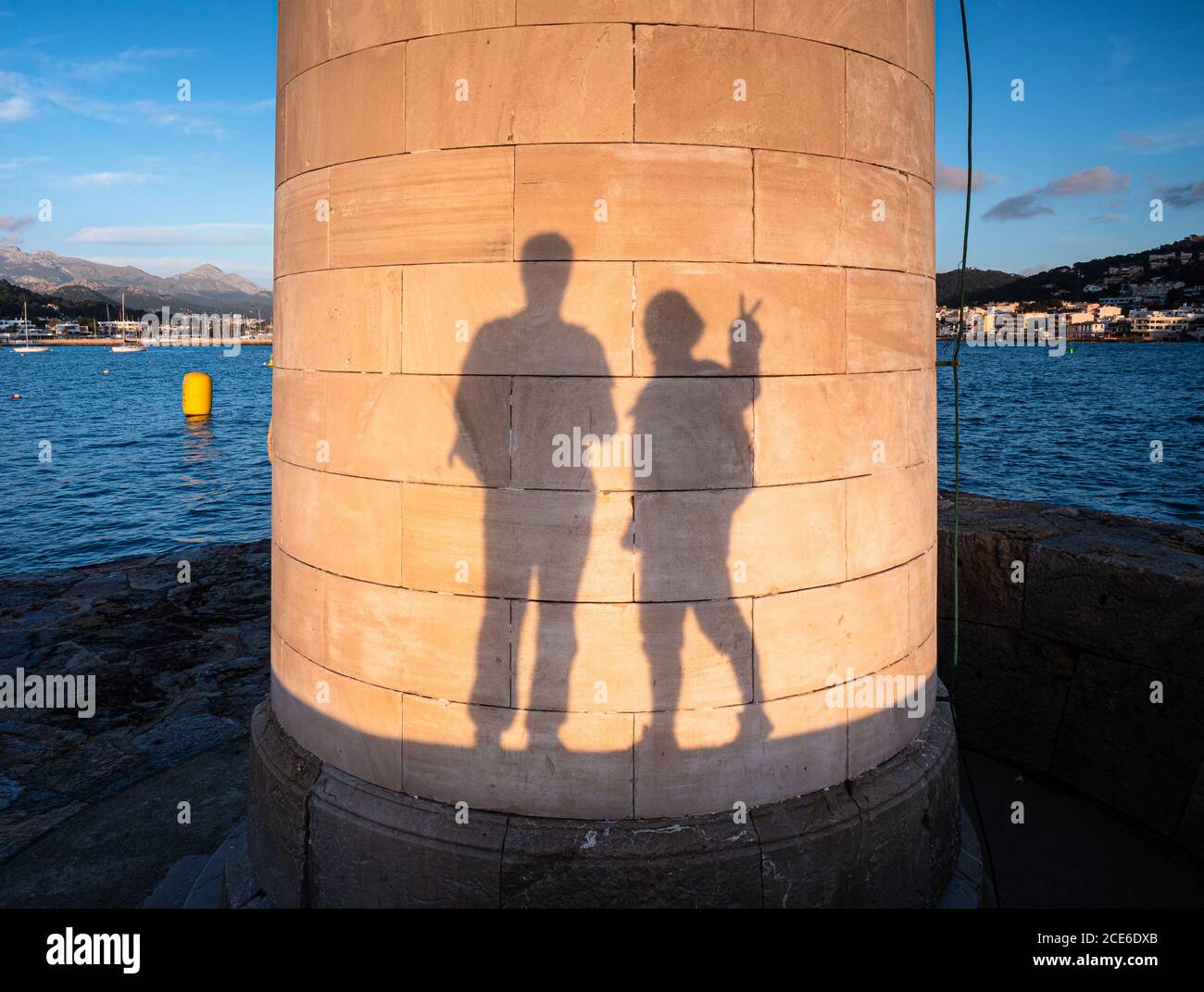 Travelers couple shadows on wall of Lighthouse Stock Photo - Alamy