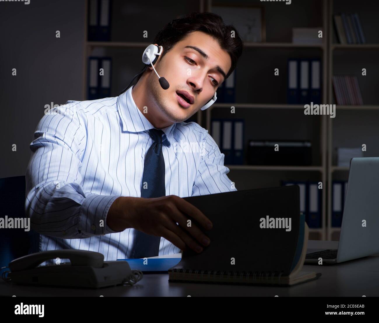 The tired and exhausted helpdesk operator during night shift Stock ...