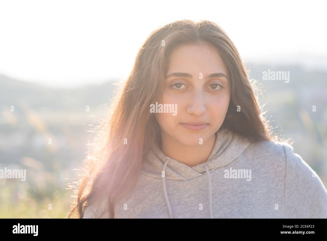 Beautiful teenage girl looking at camera Stock Photo - Alamy