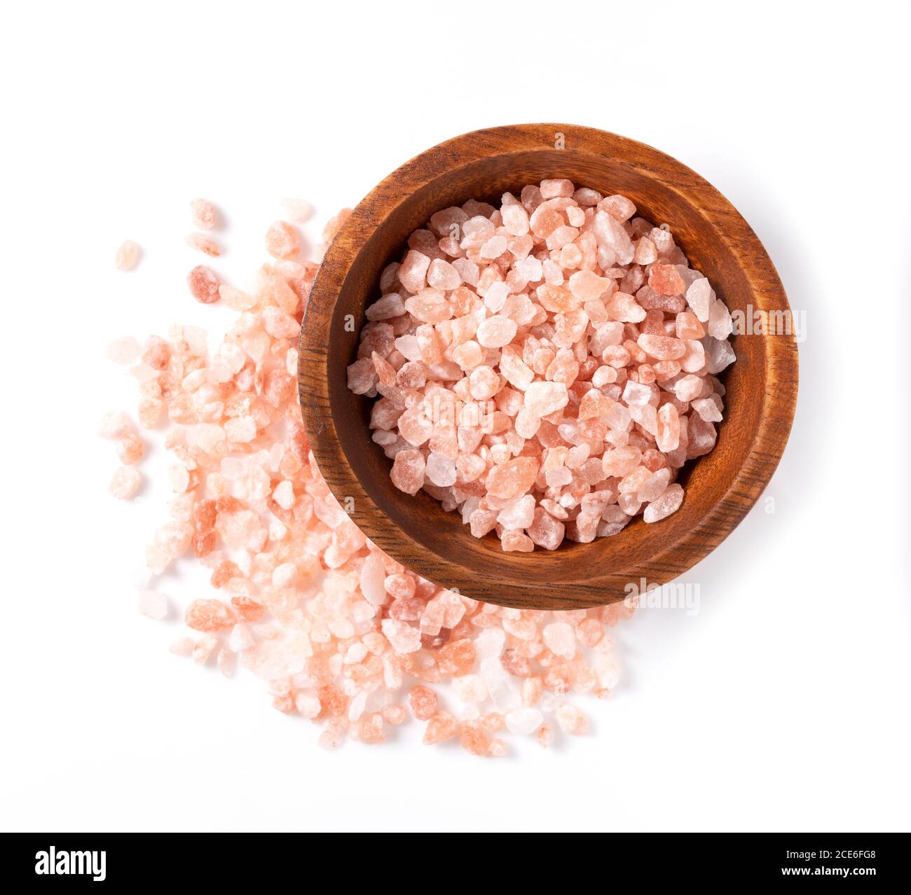 Take a bird's eye view of pink rock salt in a wooden bowl placed on a ...