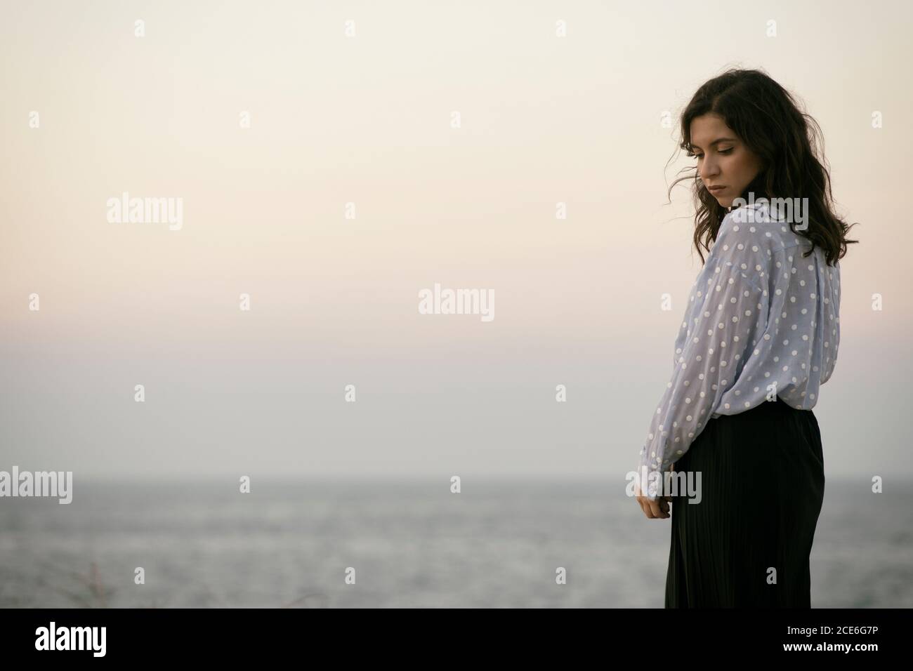 Sad woman by the sea Stock Photo - Alamy