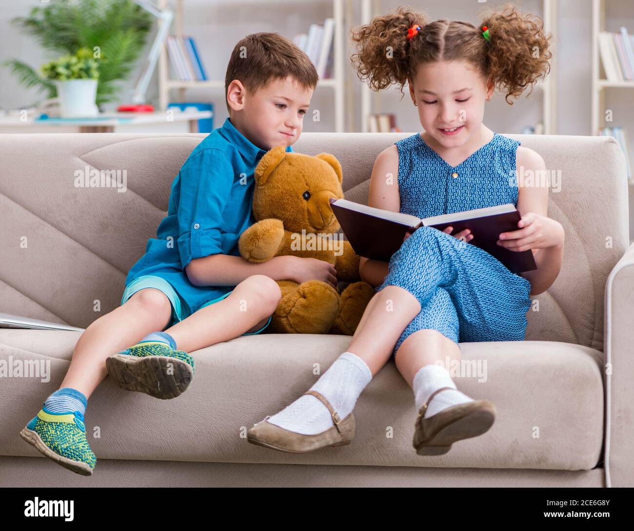 The two kids reading books at home Stock Photo - Alamy
