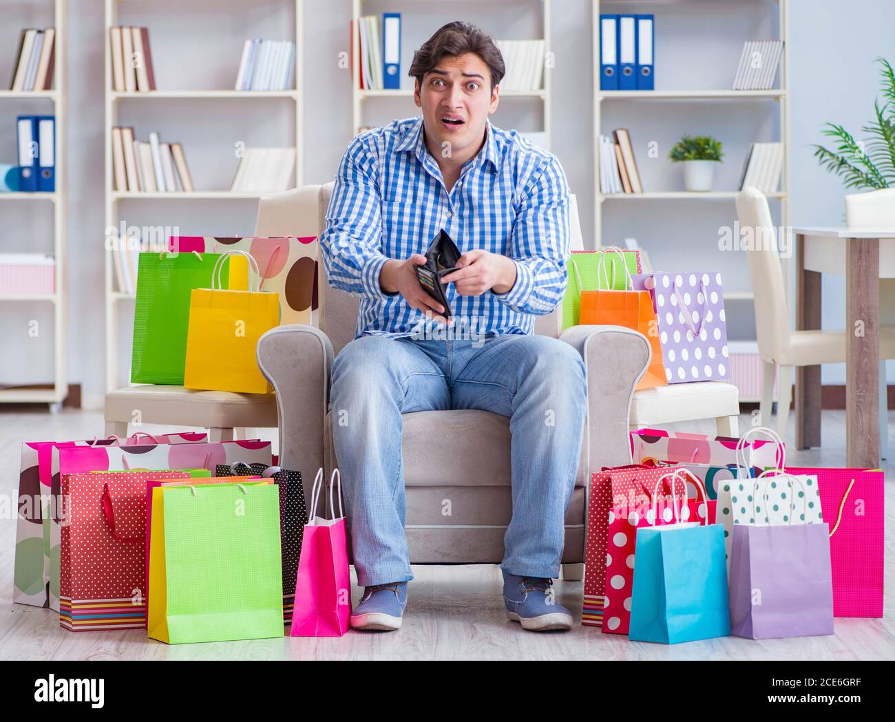 The young man after excessive shopping at home Stock Photo - Alamy