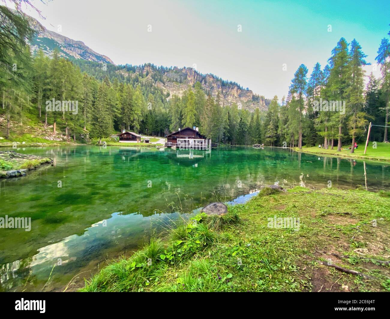 Beautiful hut on a mountain lake surrounded by forest trees Stock Photo ...