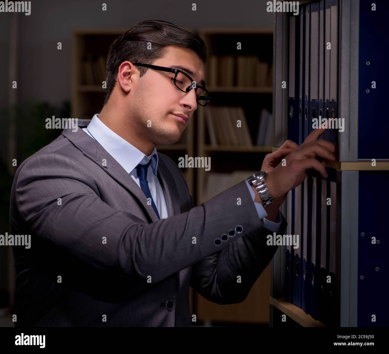 Businessman almost falling asleep working late hours in the office ...