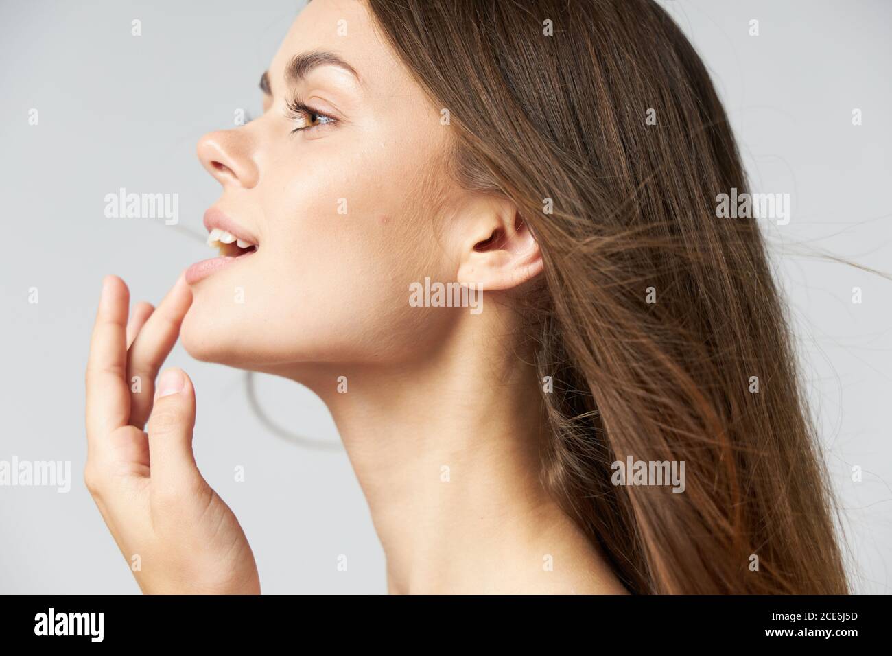 woman portrait hand near face smile side view Stock Photo - Alamy