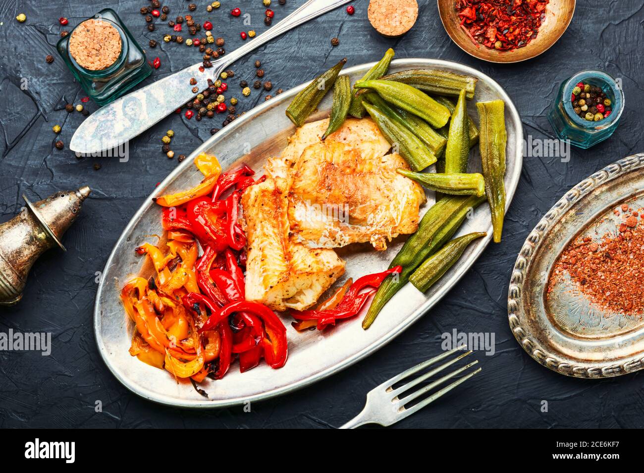 Baked fish with okra and red pepper.Fish grenadier Stock Photo - Alamy