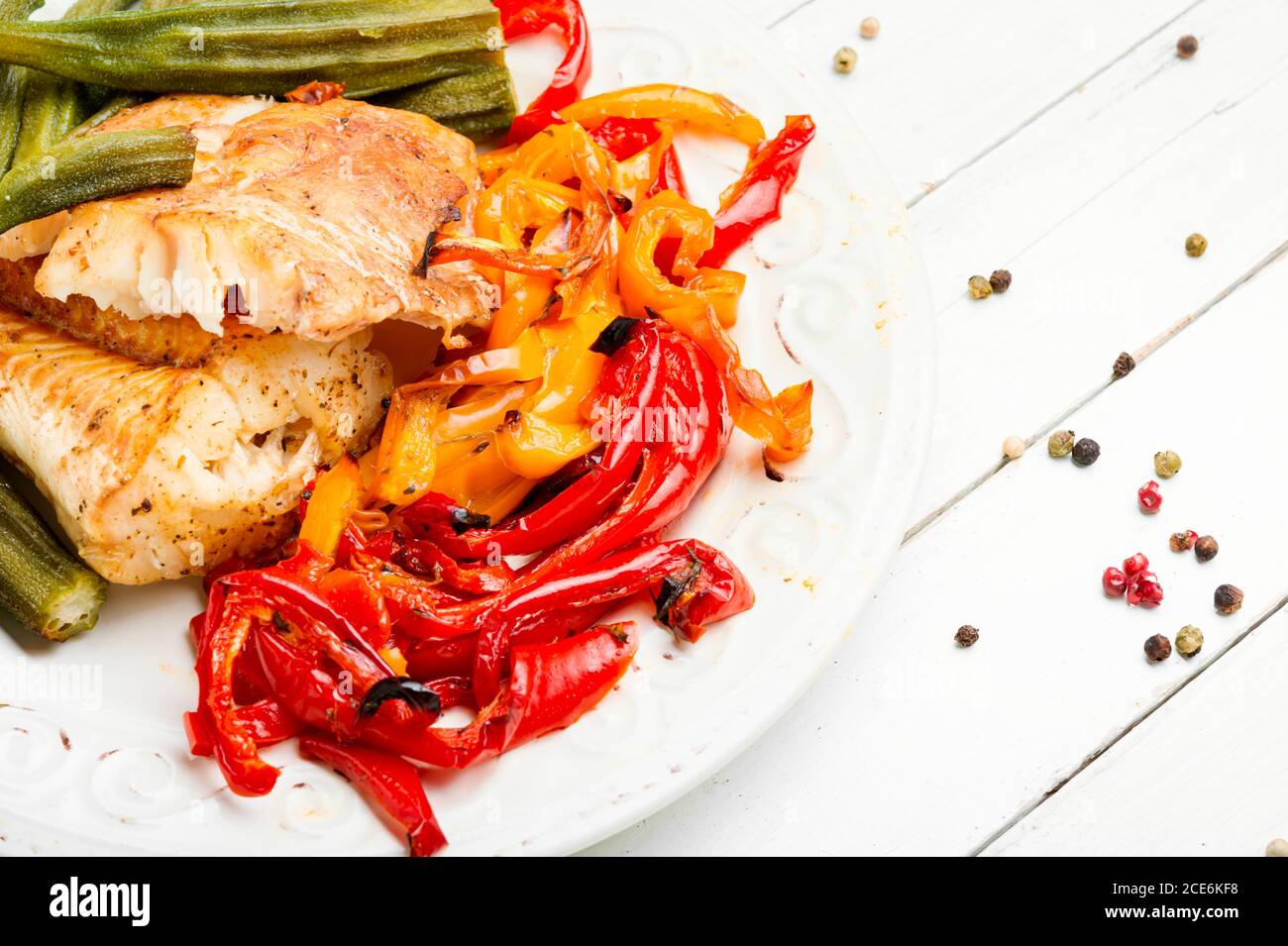 Fish grenadier baked with vegetables.Seafood on white background Stock ...