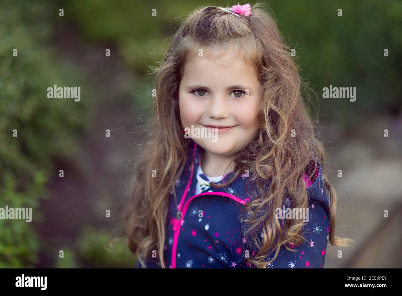 happy cute little girl with curly golden hair Stock Photo - Alamy