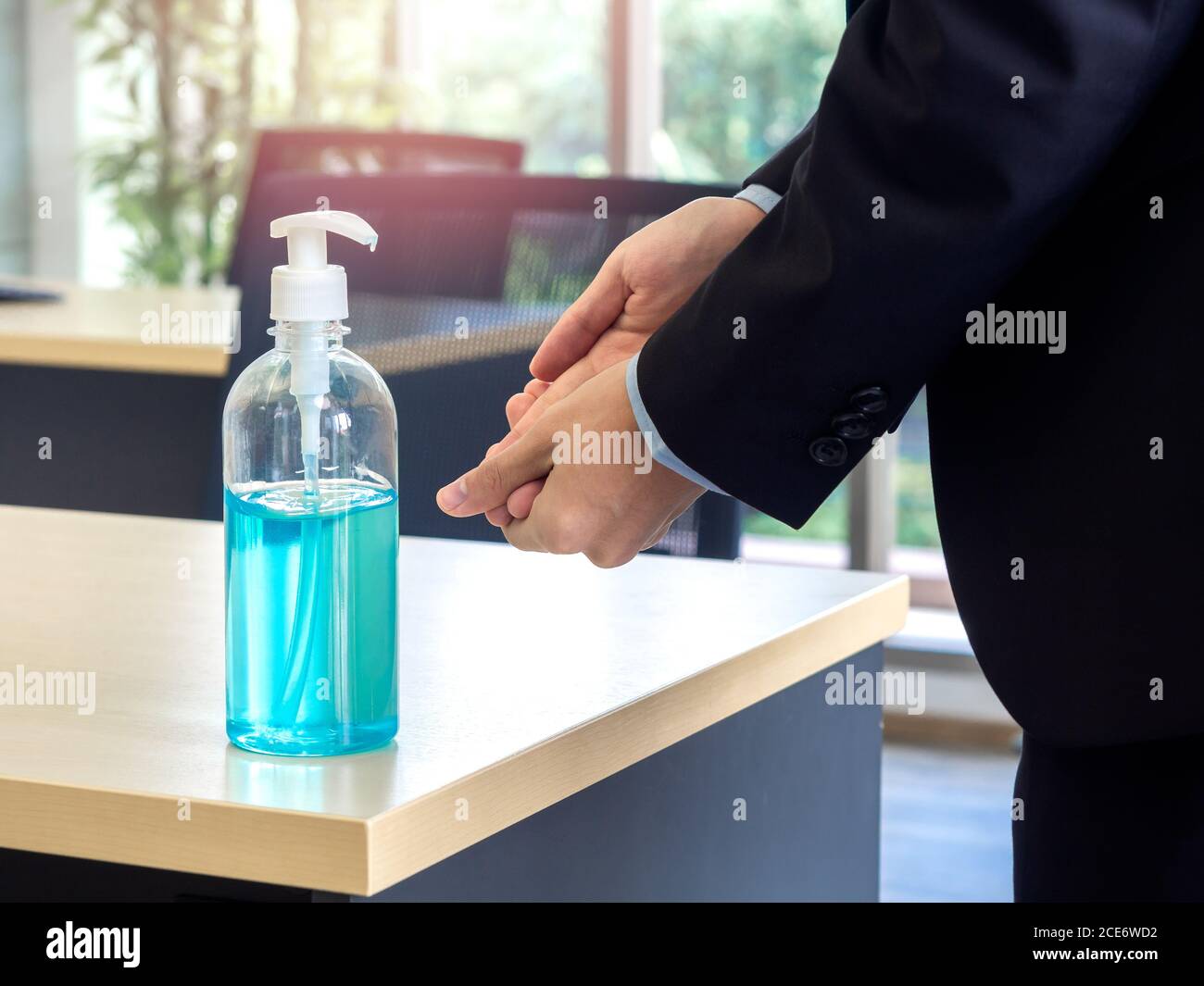 Hand disinfection with alcohol gel. Businessman's hands using the ...