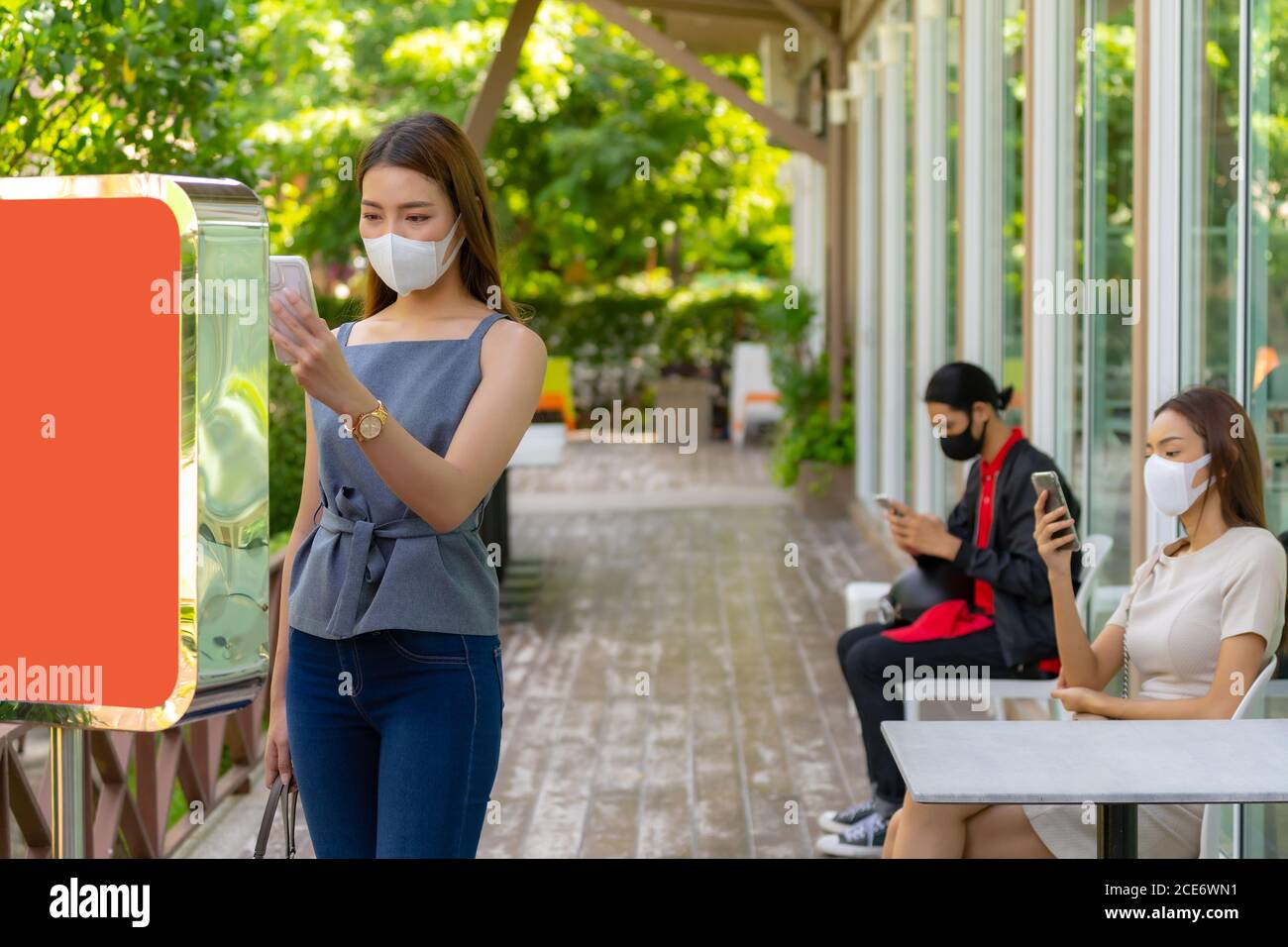 Asian woman scanning online queue for restaurant Stock Photo - Alamy