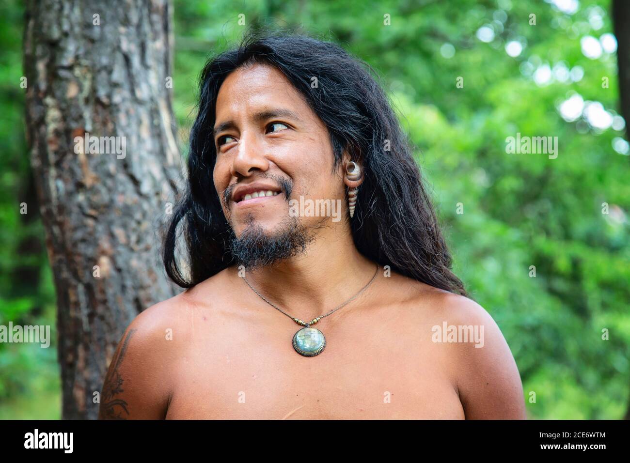 Young native american man in the forest with crystal quartz necklace ...