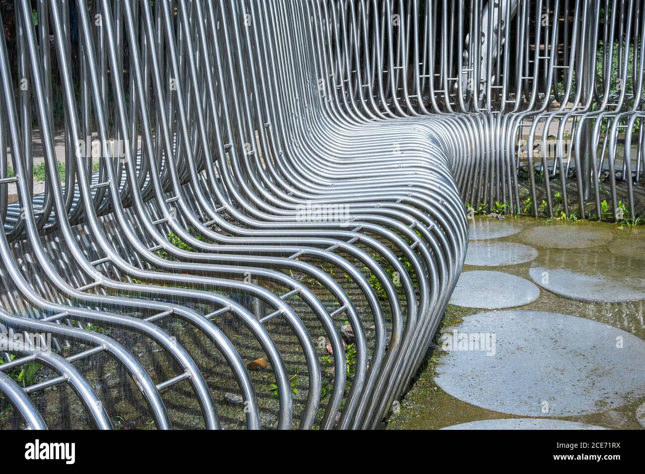 art metal bench in the pouring rain in the park, close-up Stock Photo ...