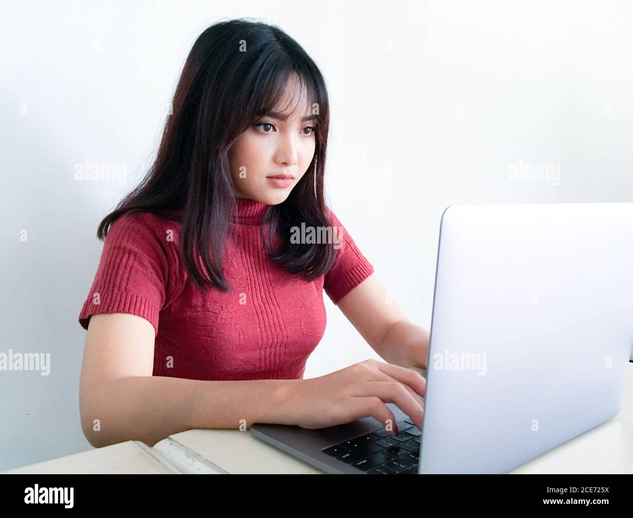 Asian beautiful girl serious or thinking in the front of laptop on the ...