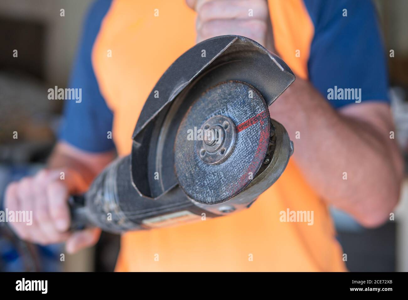 hand-held grinder close-up in the hands of the master Stock Photo - Alamy