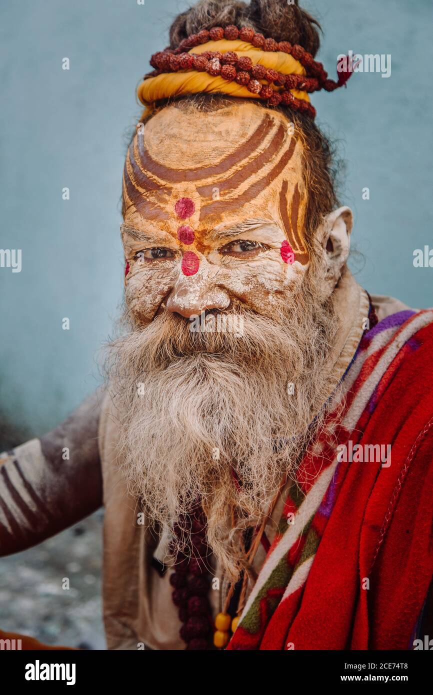India - March 9, 2020: Aged Indian male with painted face and body and ...