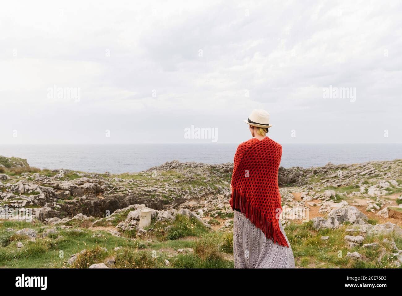 Back view of unrecognizable female traveler in stylish outfit and hat ...