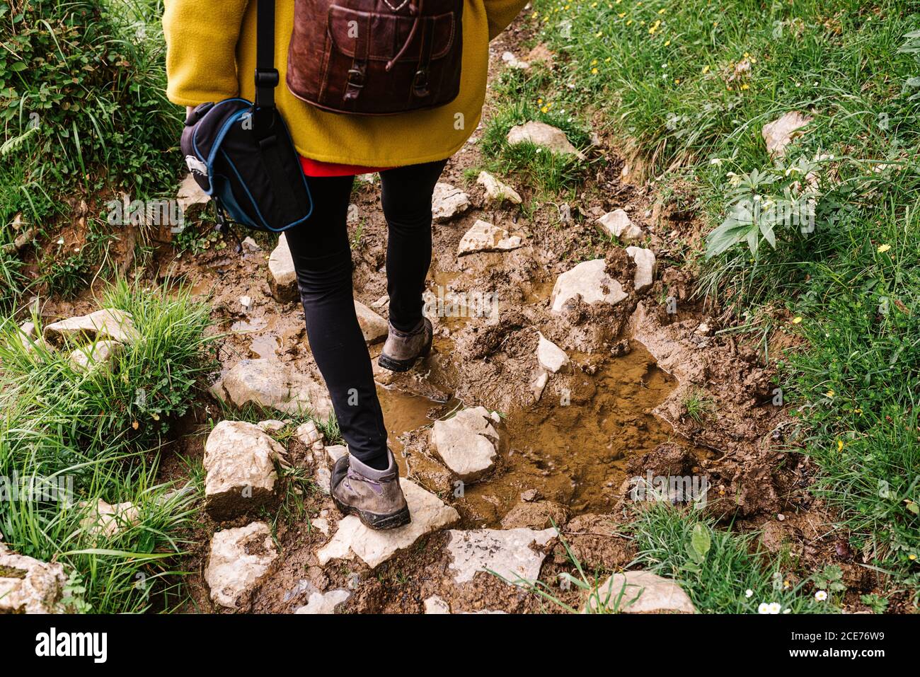 High angle back view of traveling female with backpack walking down ...