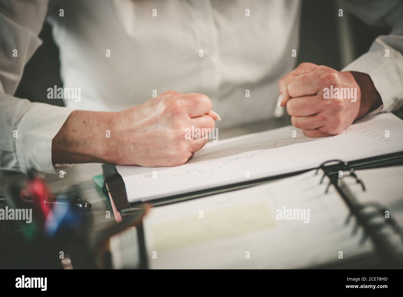 Angry businesswoman hitting her desk with her clenched fists Stock ...