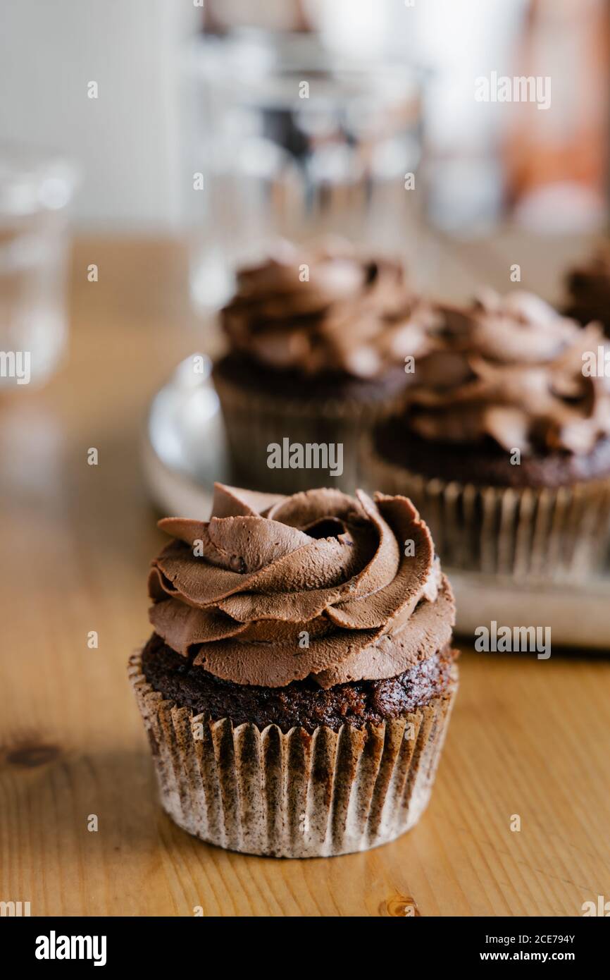 Appetizing sweet chocolate cupcakes with chocolate butter cream served ...