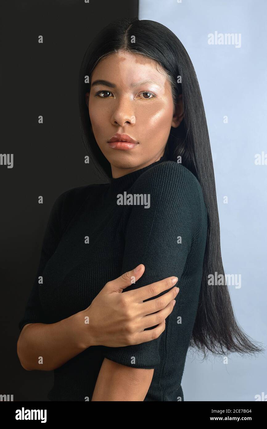 Side view of young sensual emotionless ethnic female with dark hair and ...