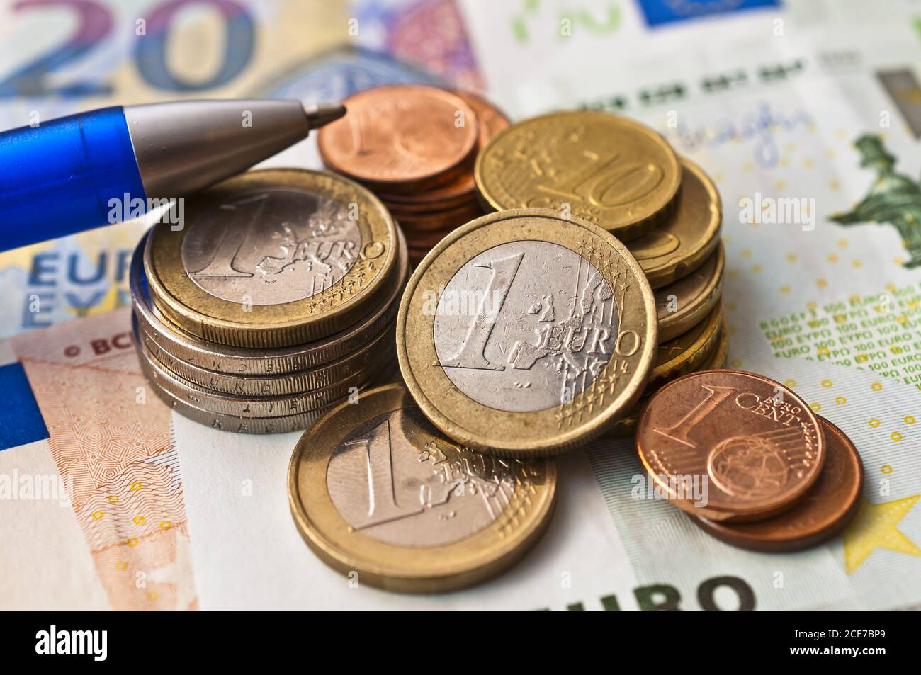 money, pen and coins euro Stock Photo - Alamy