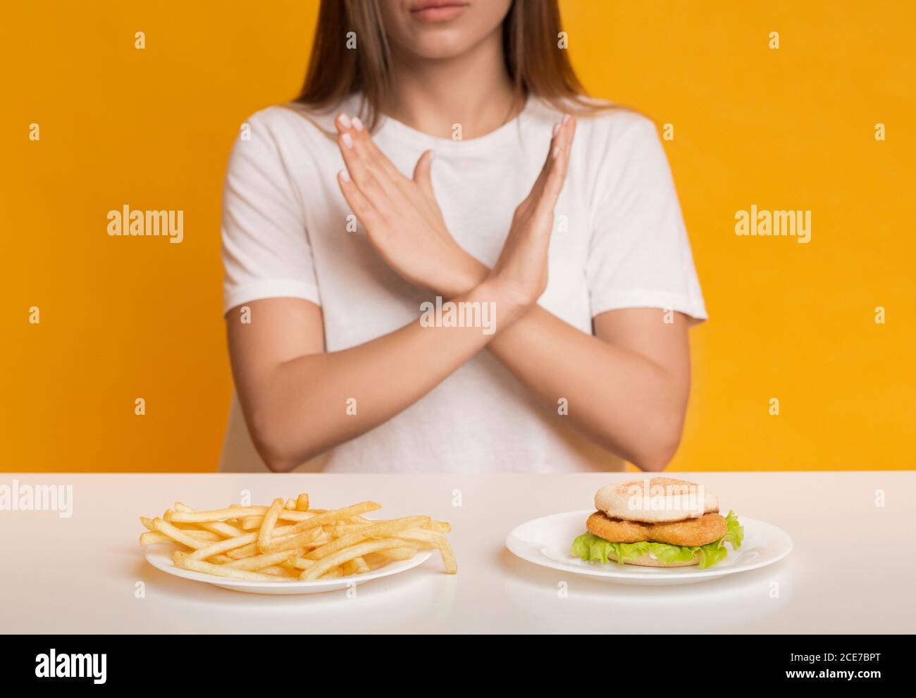Unrecognizable woman showing stop gesture, refusing unhealthy fast food ...