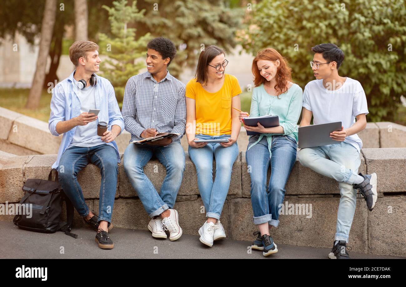 Multicultural Students Learning Together Working On Group Project ...