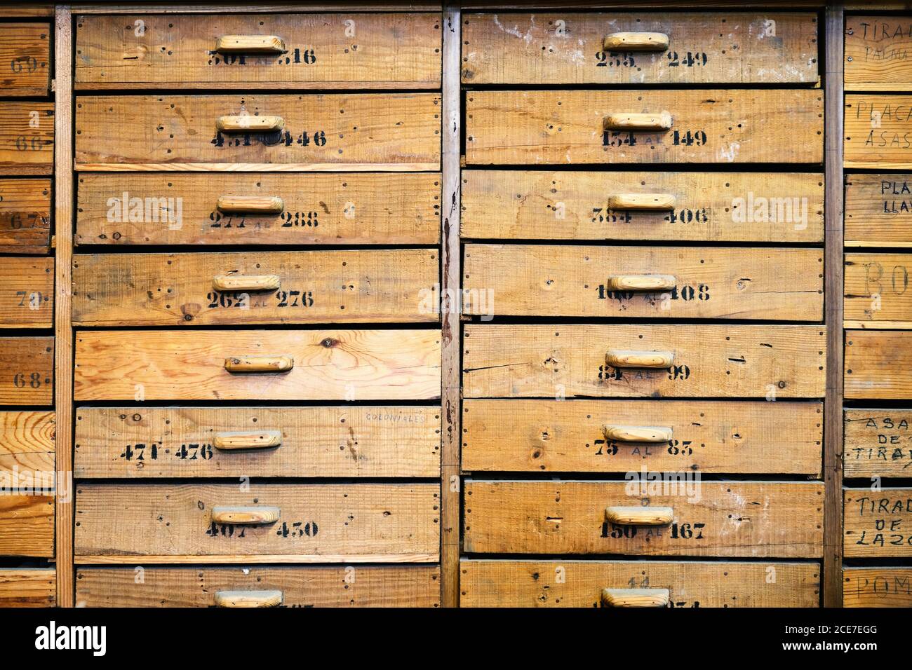 Archive representing identical light brown wooden drawers with ...