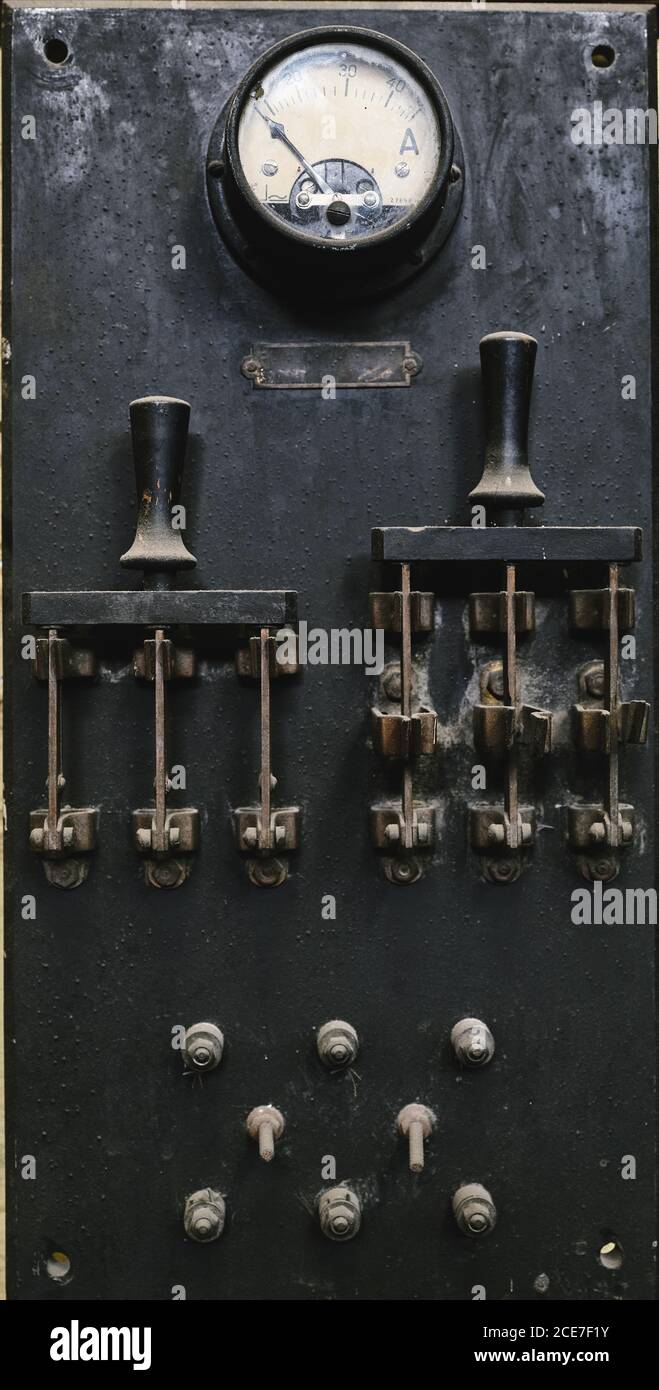 Aged metal control panel with switches and analogue gauges in craft ...
