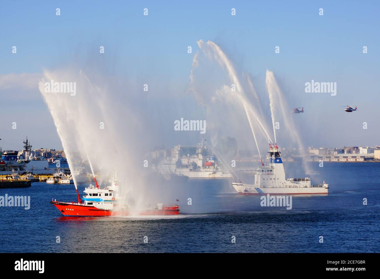 Fire fighting vessels to the water discharge training Stock Photo - Alamy