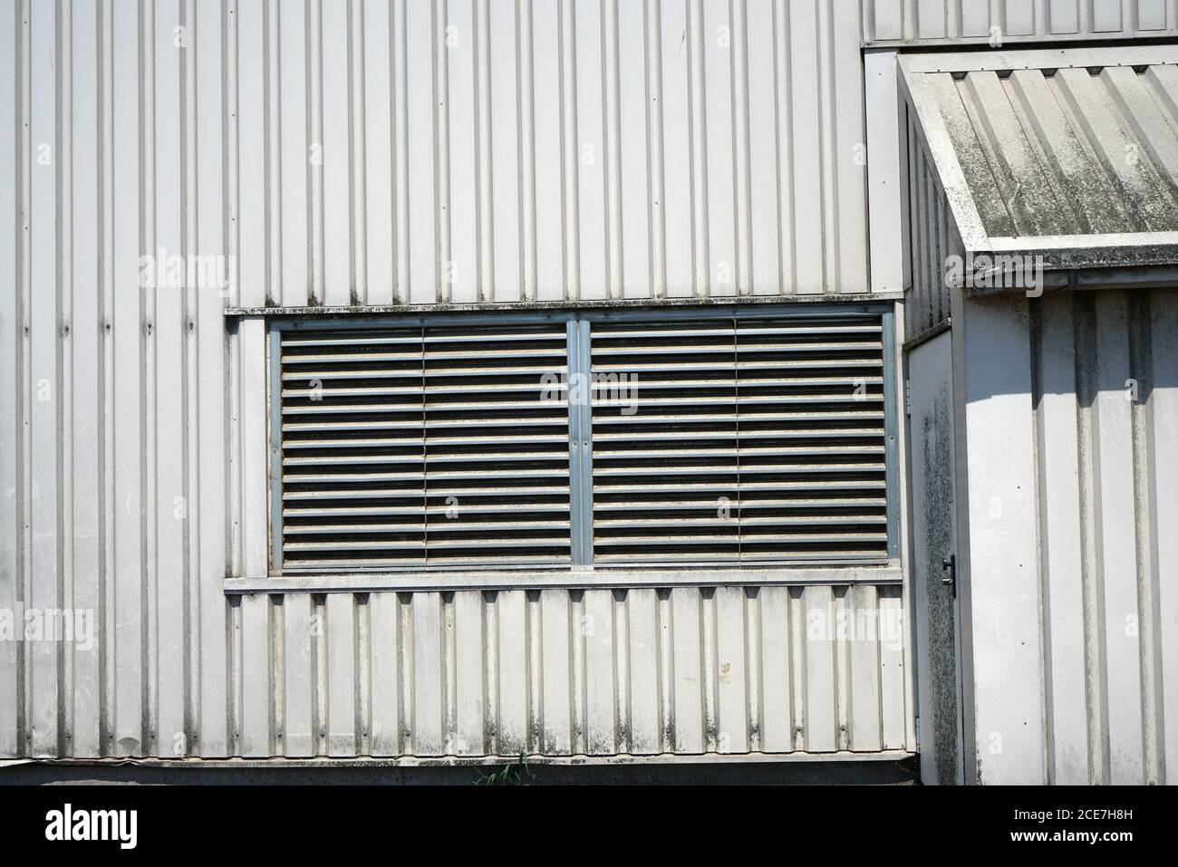 Building facade with small windows during the daytime Stock Photo - Alamy