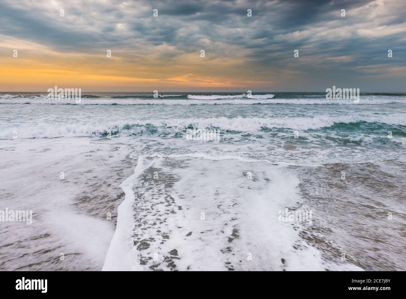 Evening light over the incoming tide at Fistral Beach in Newquay in ...