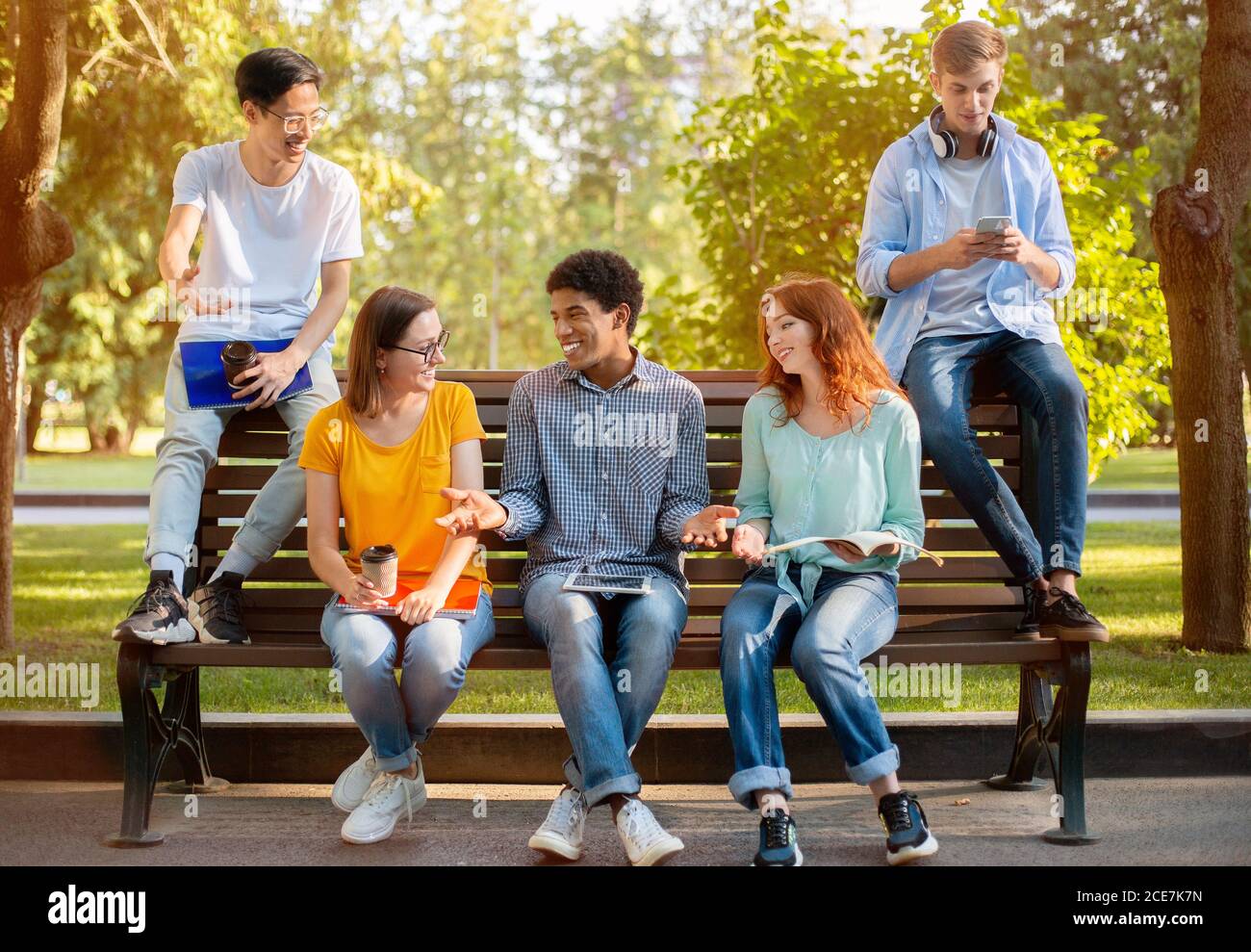 College Students Sitting On Bench