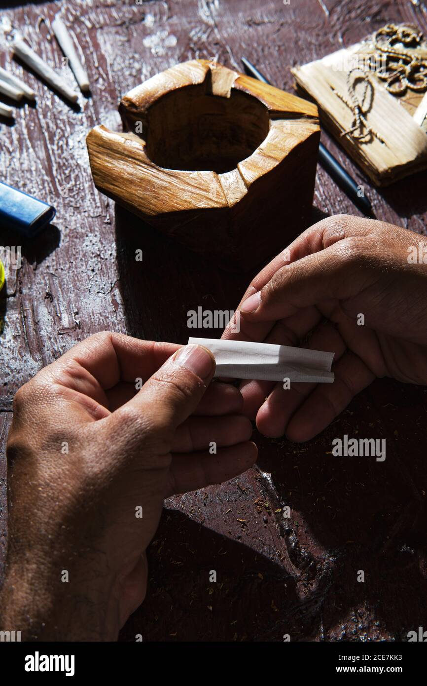unrecognizable male smoker making marijuana joint Stock Photo - Alamy