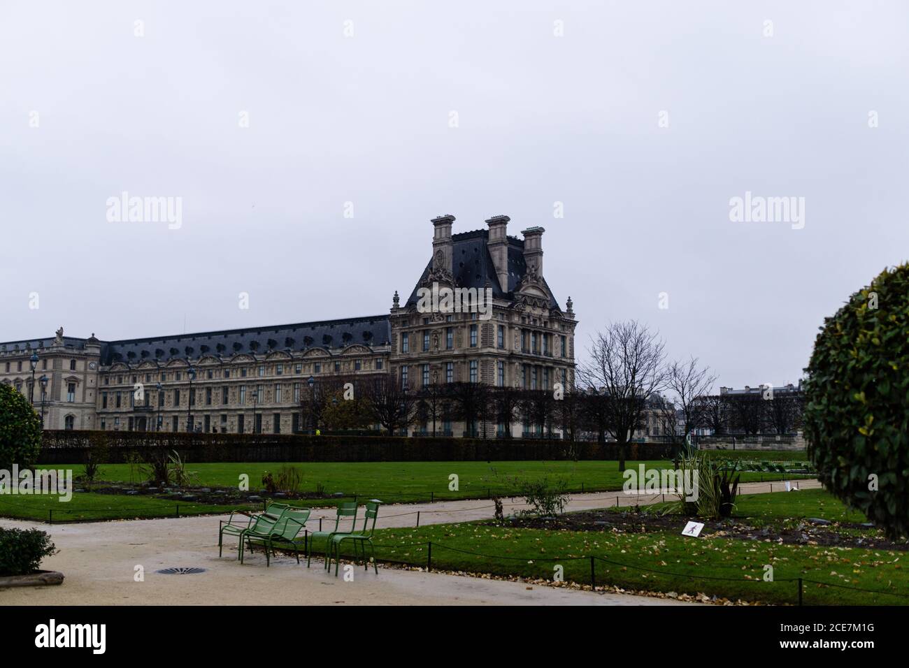 Beautiful shot of a city park in Paris with green lanes and walking ...