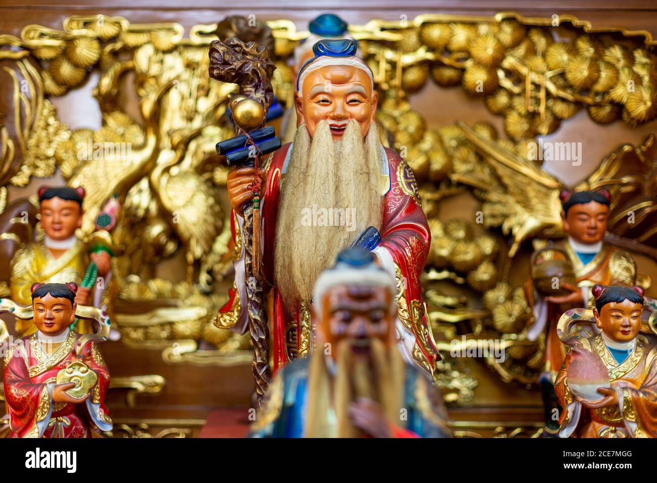 Collection of colorful Chinese statues placed on stone stairs in temple ...
